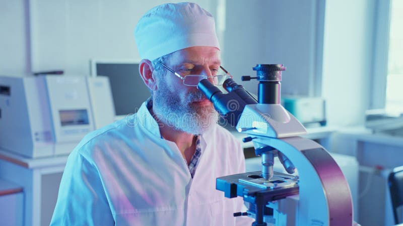 Chemist Analyzing Samples Under Microscope in Innovative Laboratory ...