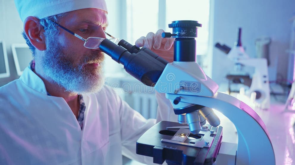 Chemist Analyzing Samples Under Microscope in Innovative Laboratory ...