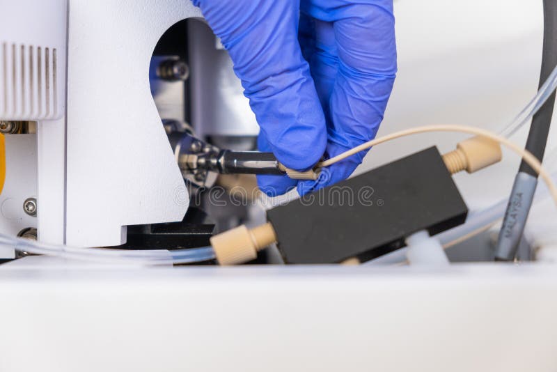 Chemist Connecting Nebulizer To Ion Source of Mass Spectrometer. Liquid ...