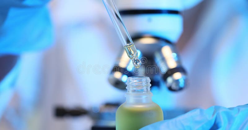 Chemist Drops Reagent into Bottle with Liquid Using Pipette Stock Video ...