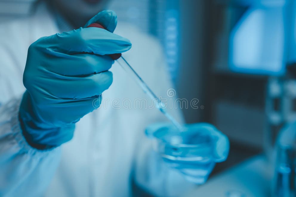 A Chemist Examines a Sample of a Liquid in a Laboratory, a Laboratory ...