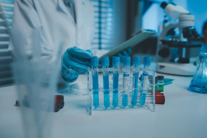 A Chemist Examines a Sample of a Liquid in a Laboratory, a Laboratory ...