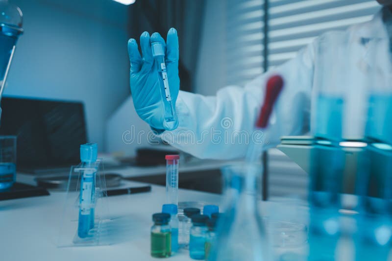 A Chemist Examines a Sample of a Liquid in a Laboratory, a Laboratory ...