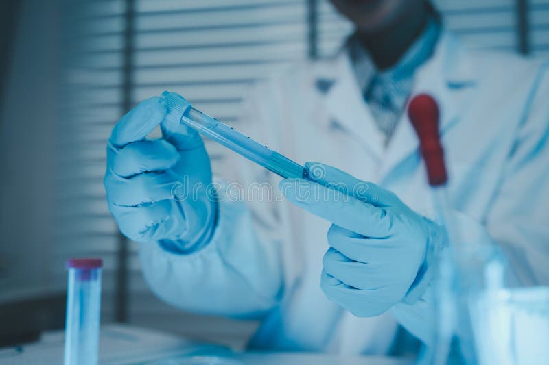 A Chemist Examines a Sample of a Liquid in a Laboratory, a Laboratory ...