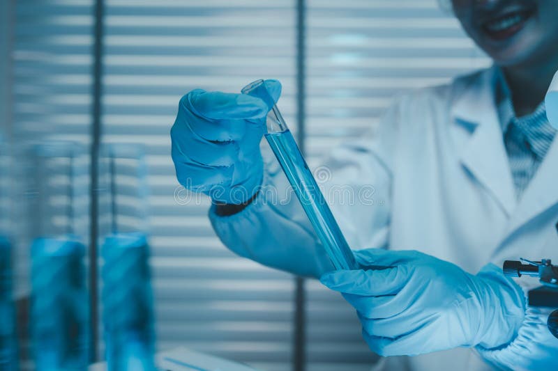 A Chemist Examines a Sample of a Liquid in a Laboratory, a Laboratory ...