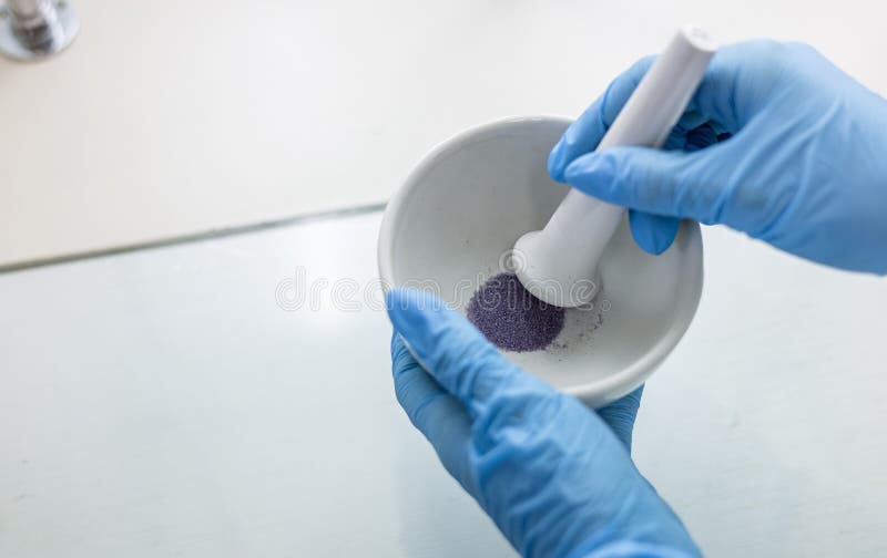 A Chemist Grinds Reagents in a Mortar. Preparing a Reagent for ...