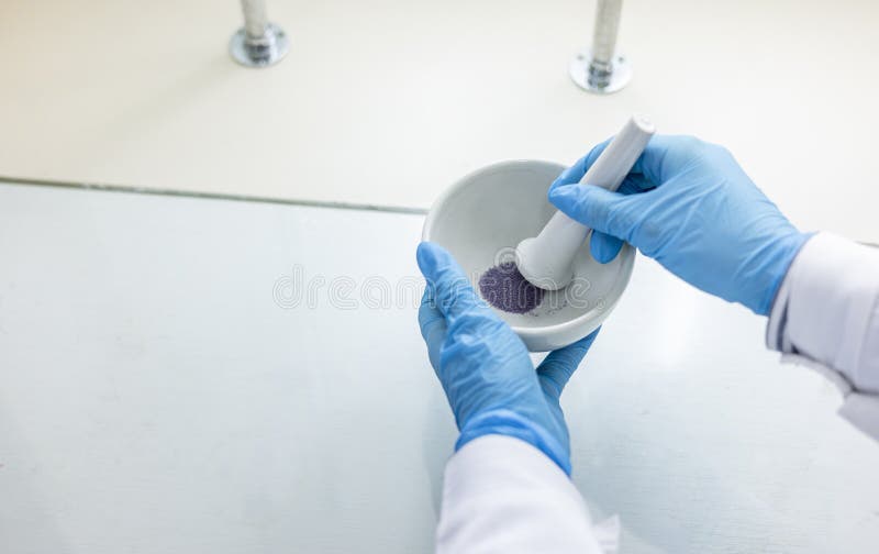 A Chemist Grinds Reagents in a Mortar. Preparing a Reagent for ...