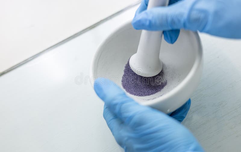 A Chemist Grinds Reagents in a Mortar. Preparing a Reagent for ...