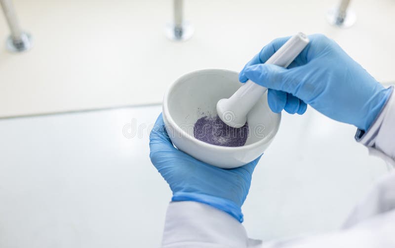 A Chemist Grinds Reagents in a Mortar. Preparing a Reagent for ...