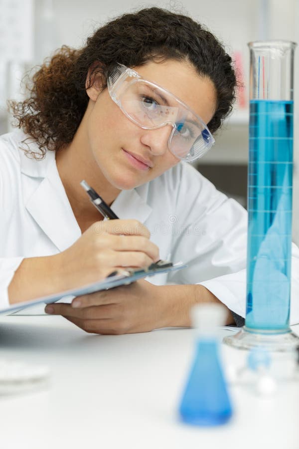 Chemist Looking at Test-tubes with Blue Liquids Stock Photo - Image of ...
