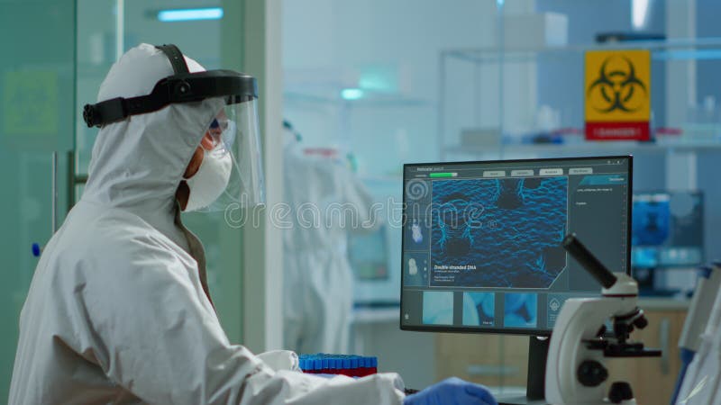 Chemist in Ppe Suit Typing on Computer Checking Vaccine Development ...