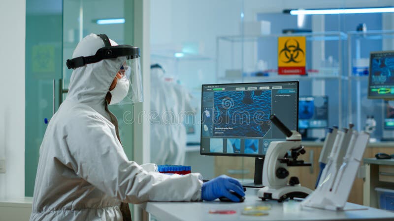 Chemist in Ppe Suit Typing on Computer Checking Vaccine Development ...