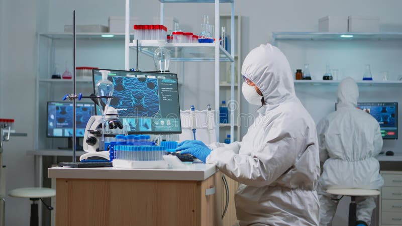 Chemist in Ppe Suit Typing on Computer Checking Virus Development Stock ...