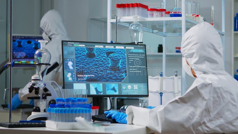 Chemist in Ppe Suit Typing on Computer Checking Virus Development Stock ...