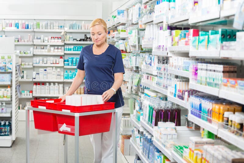 Chemist with Products in Baskets at Pharmacy Stock Photo - Image of ...