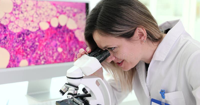 Chemist Scientist Looking at Microscope in Front of Screen with ...