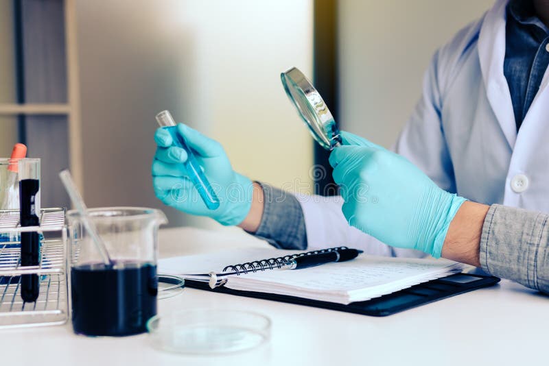 Chemist or Scientist Using Magnifying Glass Dispense the Solution in a ...