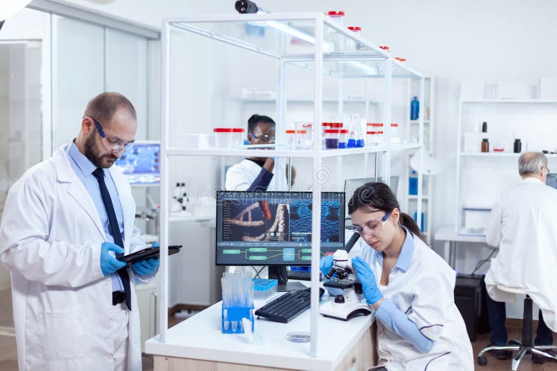 Chemist Scientists Doing Vacine Study in Busy Lab Stock Image - Image ...