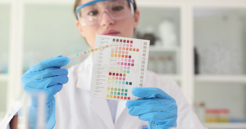 Chemist Studies Color Change of PH Test Strip To Interpret Result Stock ... Chemist Studies Color Change of PH Test Strip To Interpret Result Stock ...