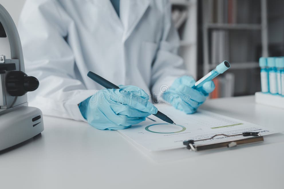 Chemist Taking Notes on Research Data, Scientist is Working in the ...