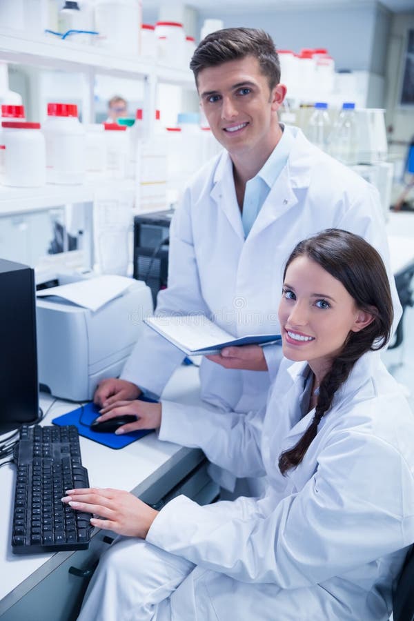 Chemist Team Working Together at Desk Using Computer Stock Photo ...