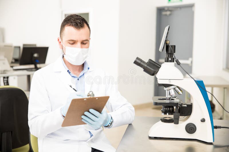 Chemist Working with a Microscope Stock Photo - Image of modern, busy ...