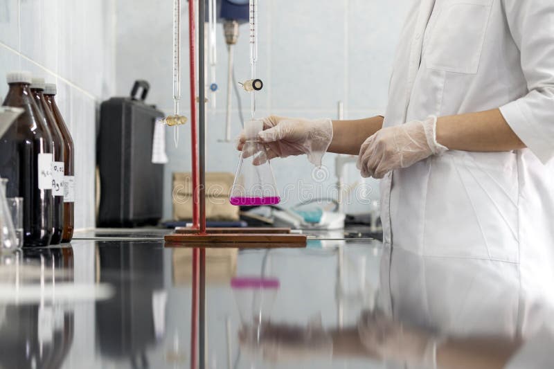 Chemistry Expert is Working with Solutions and Test Tubes on the ...