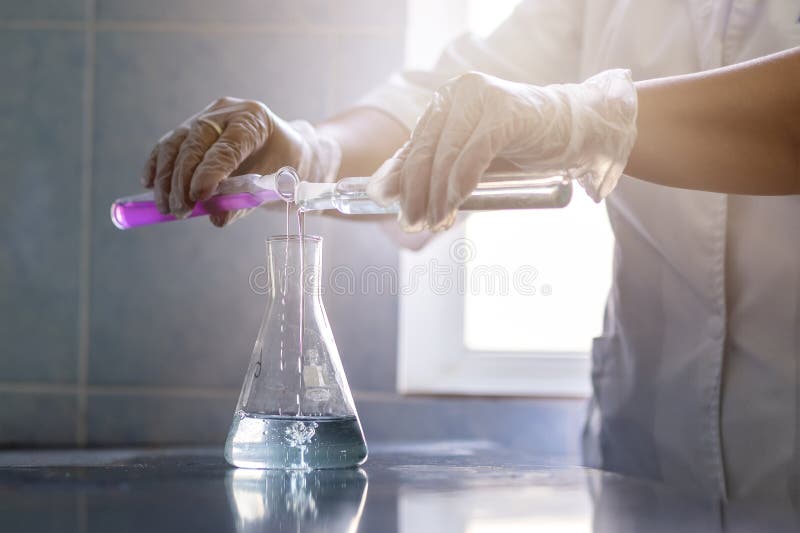 Chemistry Expert is Working with Solutions and Test Tubes on the ...