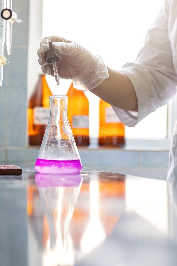 Chemistry Expert is Working with Solutions and Test Tubes on the ...