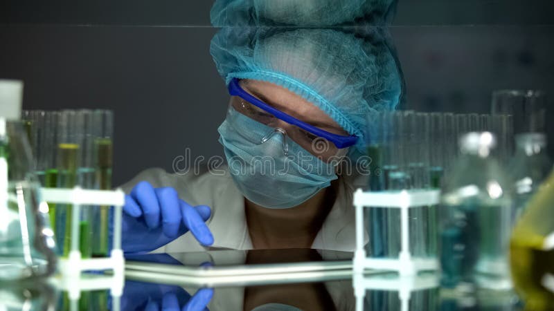 Chemistry Student Adding Experiment Data To Report on Tablet PC ...