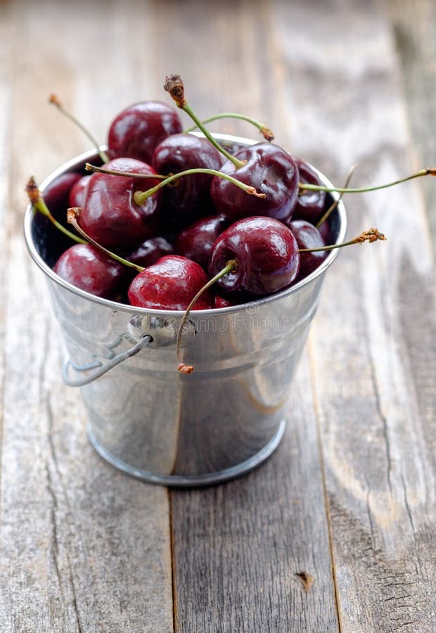Cherries in a Bucket on a Wooden Table Stock Photo - Image of light ...