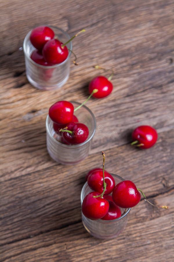 Cherries on wooden table stock image. Image of branch - 37795039