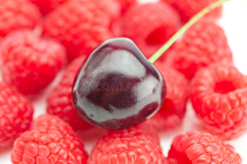 Cherry on Background of Raspberry Stock Photo - Image of close, life ...