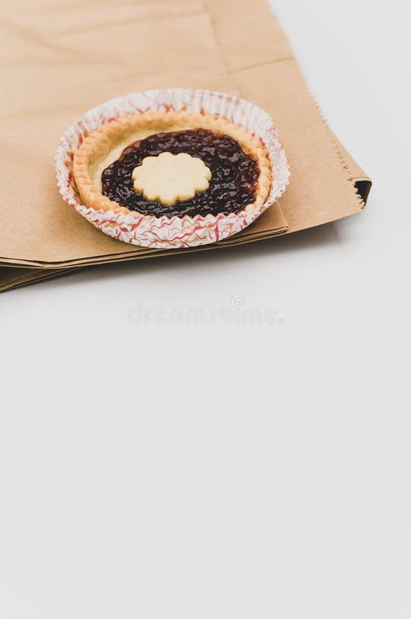 Cherry Jam Pastry in a Paper Backing Cup on a White Background Stock ...
