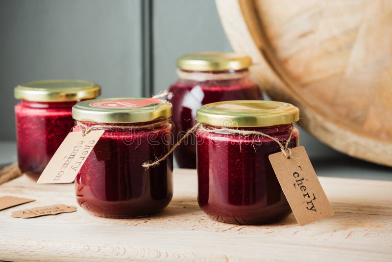Cherry jam in small jars stock image. Image of canned - 325861989