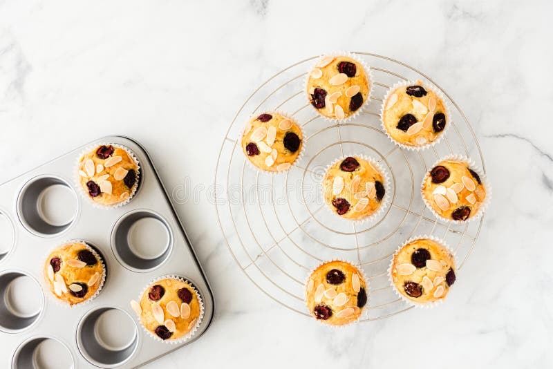 Cherry Muffins in Metal Baking Form and on Cooling Rack Over White ...