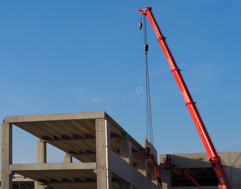 Cherry Pickers and a Telescopic Crane at Work in a Construction ...