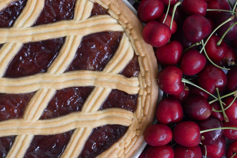 Cherry Pie with a Lattice Crust Alongside Fresh Cherries on a Table ...