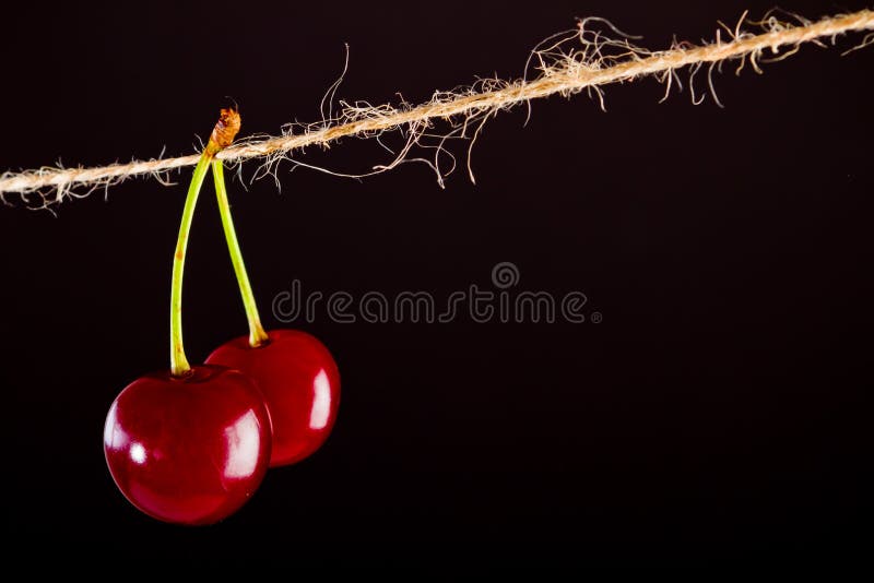 Cherry and Rope on Black with Clamp Stock Photo - Image of cherry, rope ...