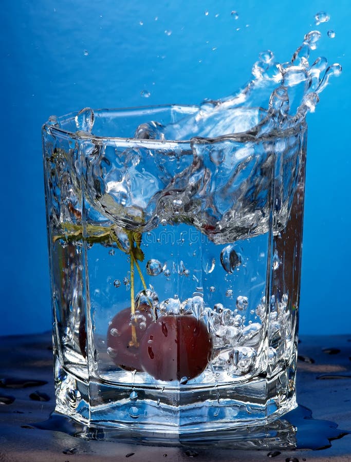 Cherry splashed into water stock image. Image of health - 10560313