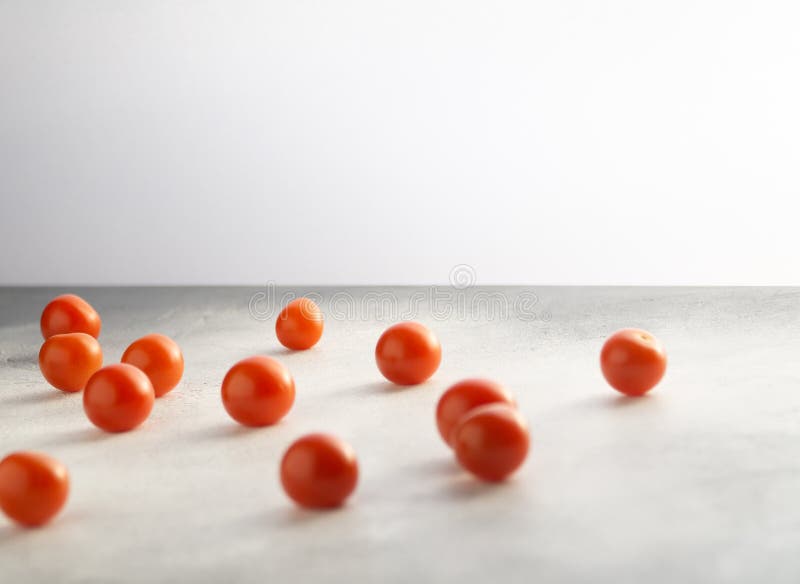 Cherry Tomatoes Scattered Across White Stone Concrete Table, with Copy ...