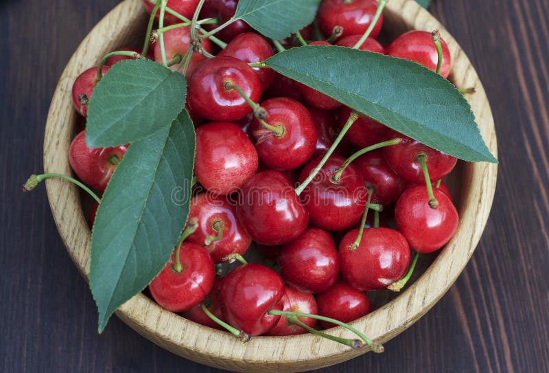 Cherry in wooden plate stock photo. Image of goodness - 72857758