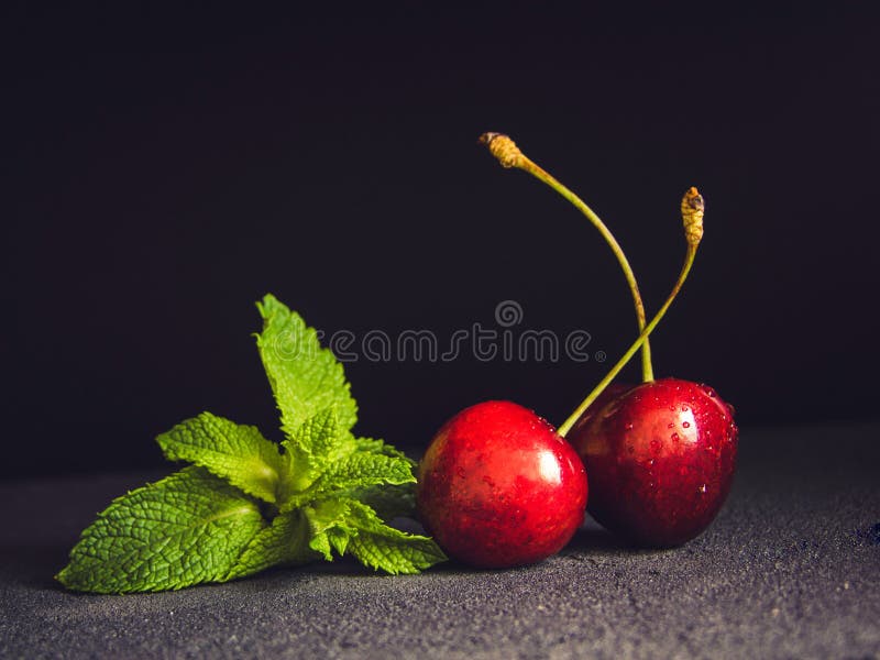 Cherry and Mint Leaves on a Black Background Stock Image - Image of ...