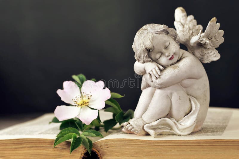 Sleeping Cherub Angel Statue with Wings for a Bed Stock Photo - Image ...