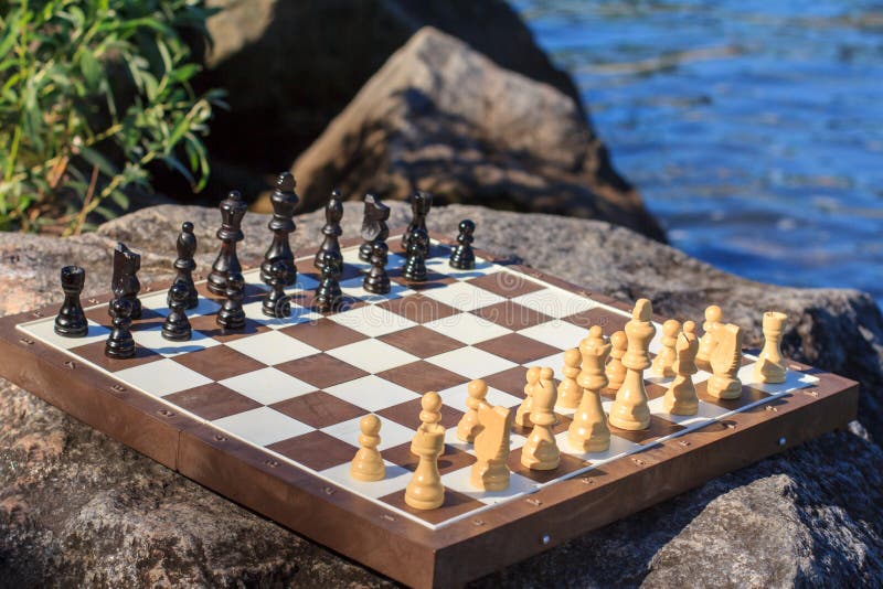 Chess Board with Chess Pieces on Rock with River Embankment Back Stock ...