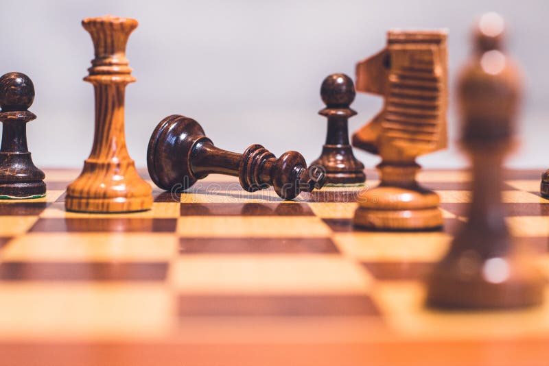 Chess Board with the Chips and the King Lying in Checkmate Stock Photo ...