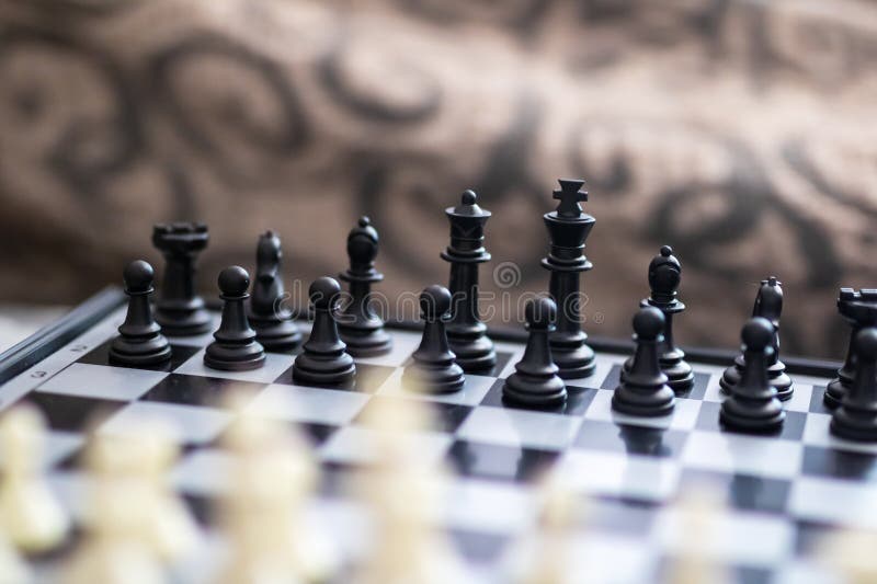 A Chess Board Featuring Both Black and White Pieces on Its Surface ...