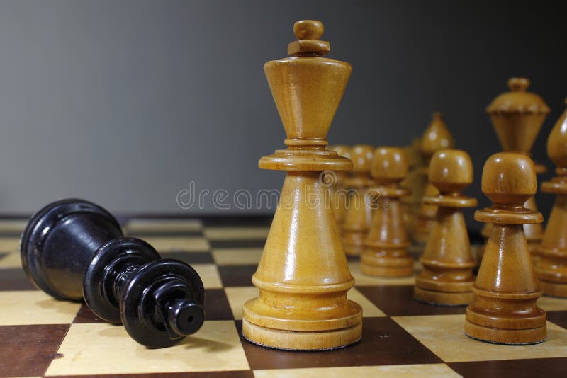 King among Fallen Chess Pieces on Black Table Against Dark Background ...