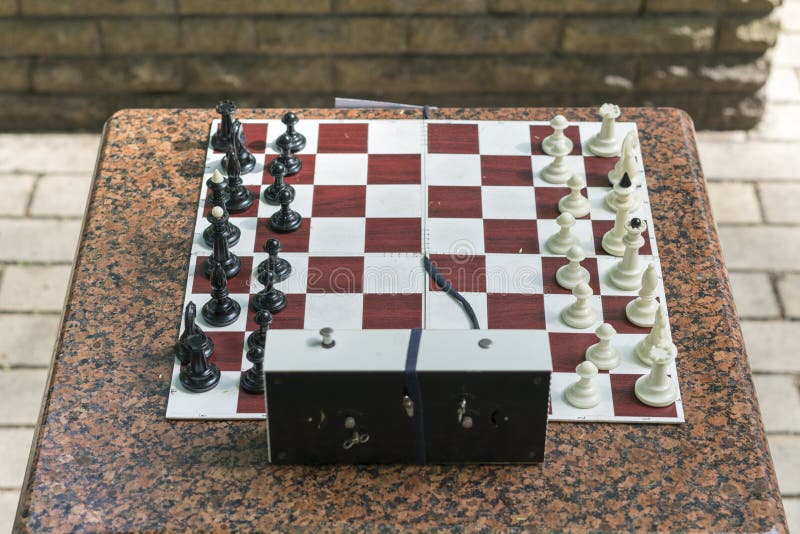 Chess Board with Pieces and Clock on Wooden Desk in Connection with the ...