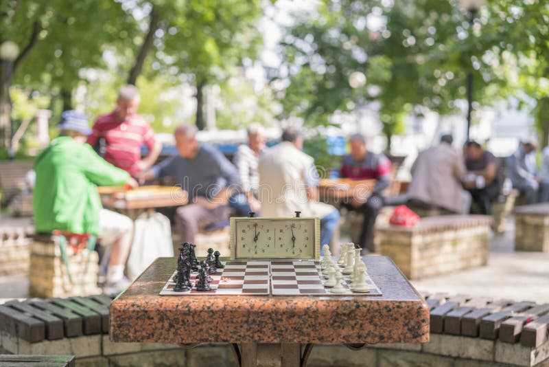 Chess Board with Pieces and Clock on Wooden Desk in Connection with the ...